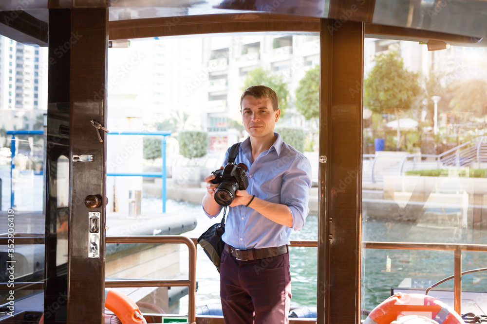 Man with a camera on a river ship. Photographer tourist on the deck of ...