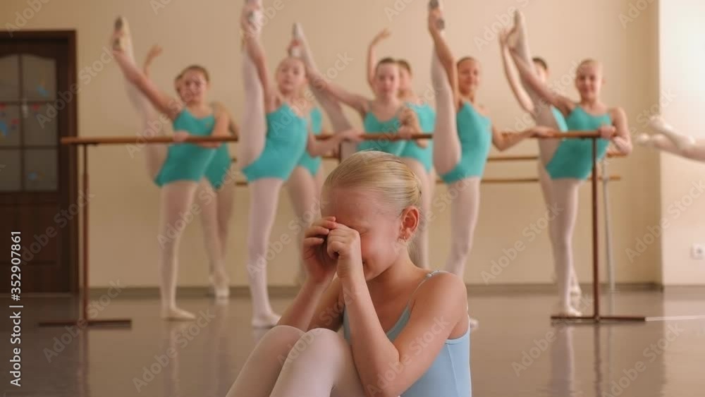 Close-up portrait of a little upset girl in a ballet Studio, she is ...