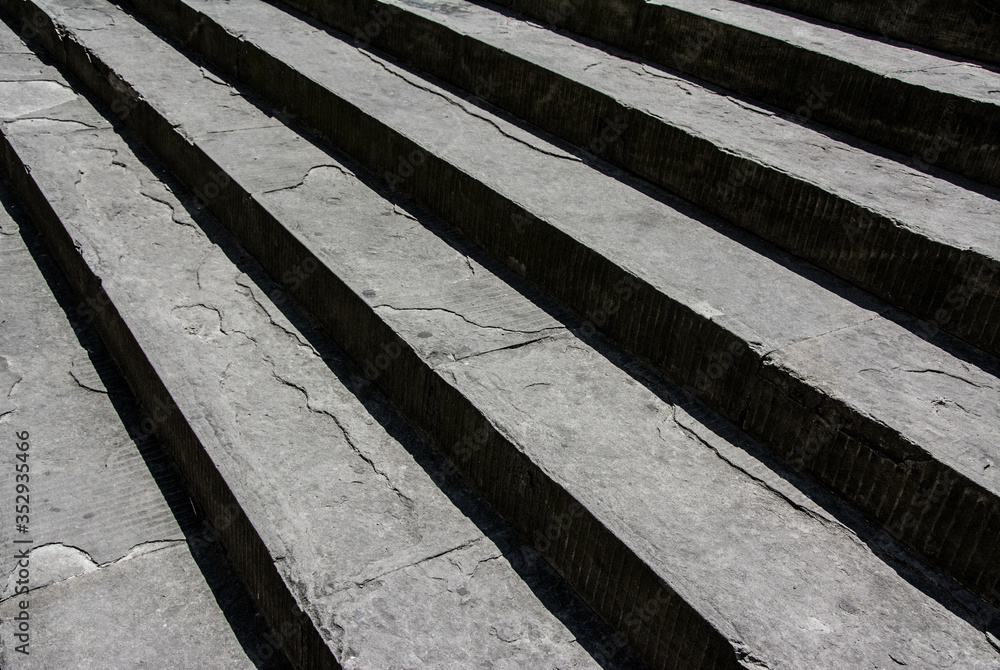 Old stone steps with the vertical faces in deep shadow to form ...