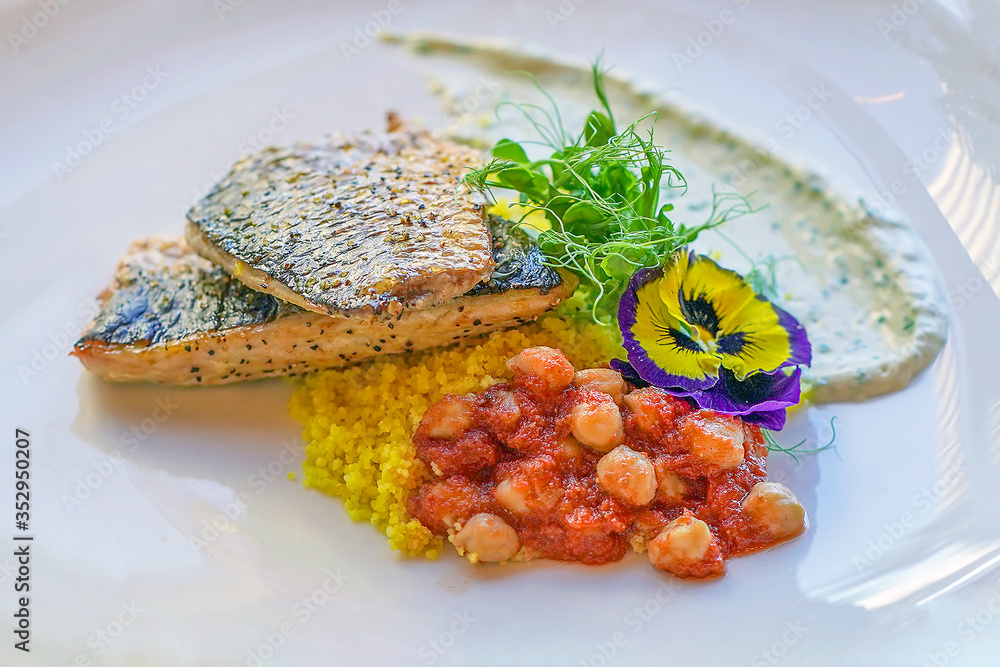 Closeup perfectly executed mullet fillet steak with crispy fish skin ...
