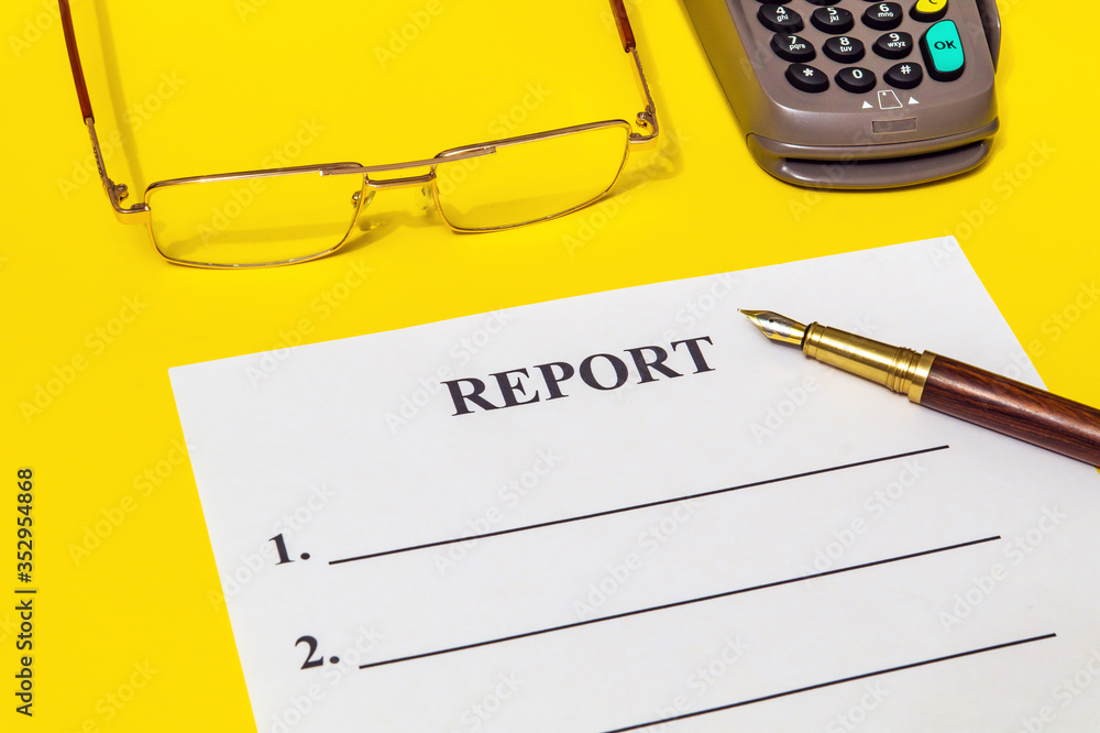 The report form on the yellow office desk with glasses and pen Stock ...