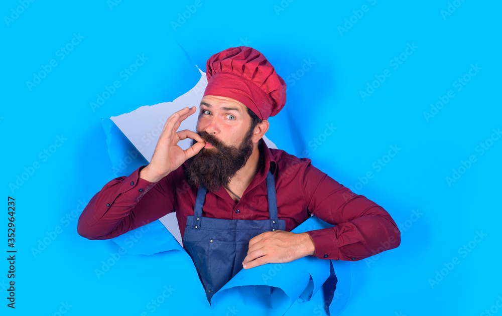 Professional chef man showing sign for delicious. Male chef in uniform ...