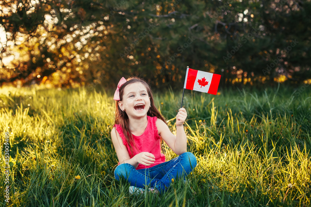 Adorable cute happy Caucasian girl holding Canadian flag. Smiling child ...