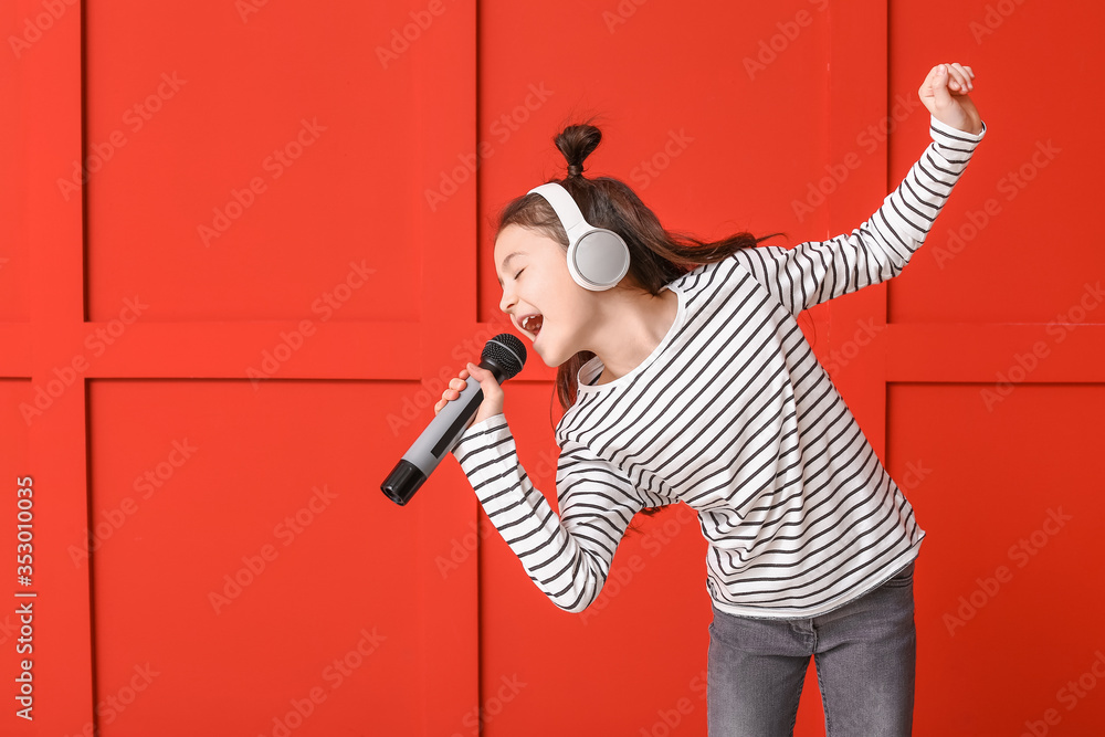 Cute little girl singing against color background Stock Photo | Adobe Stock