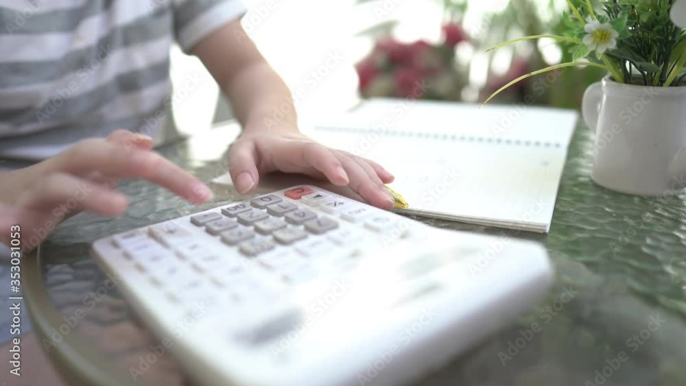 A Girl Calculating number in the calculator Stock ビデオ | Adobe Stock