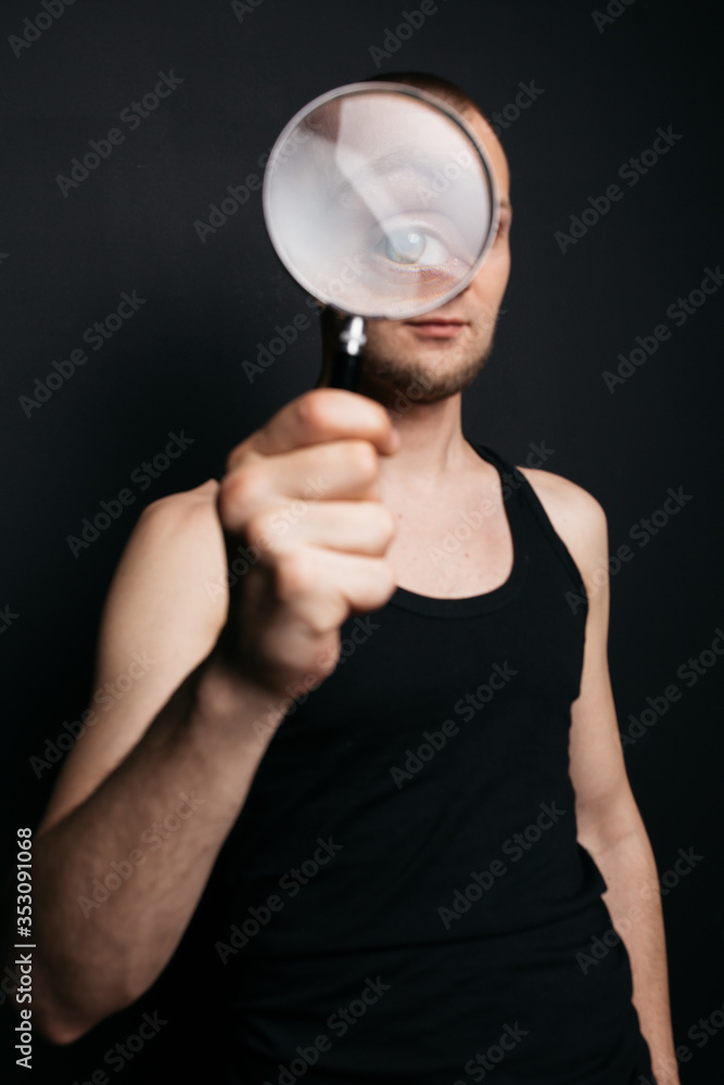 curious guy with a short haircut and a small beard looks at the world ...