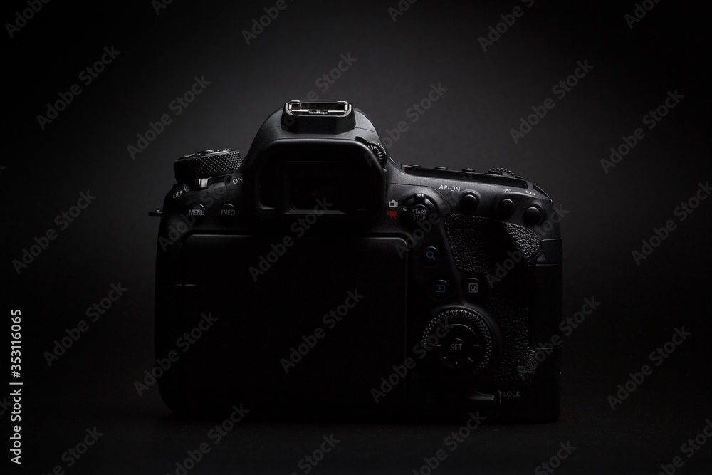 Modern professional DSLR camera in low key black background Stock Photo ...