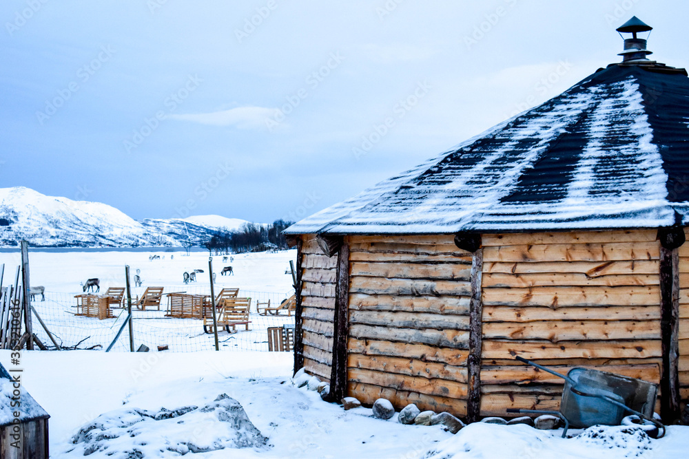 Snowy wooden cabin in the Sami camp in the Tromso fjord Stock Photo ...