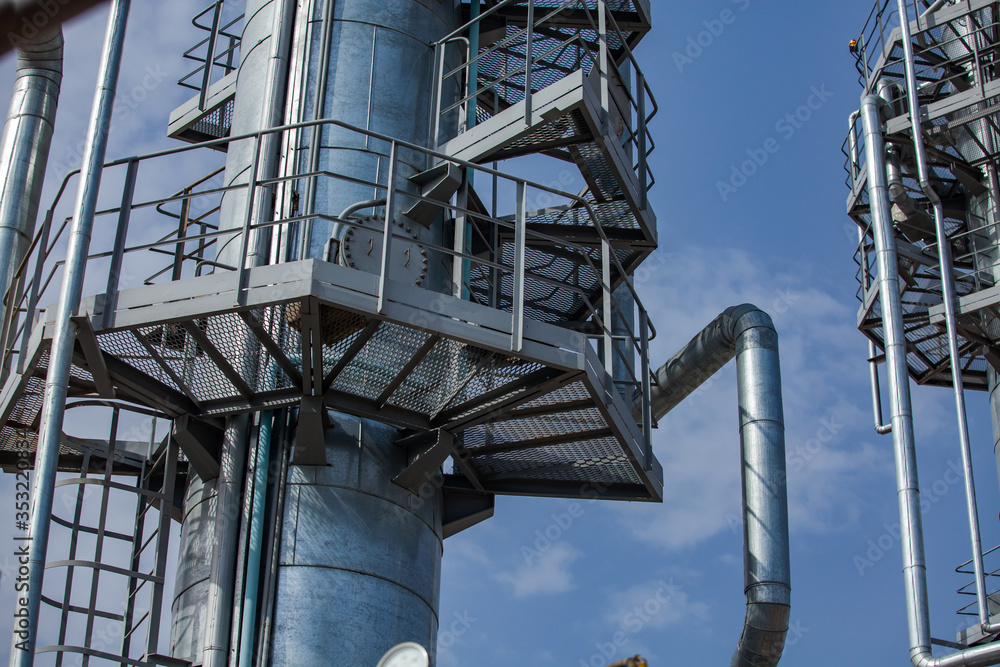 Grey pipes and distillation towers (refining columns) of oil refinery ...