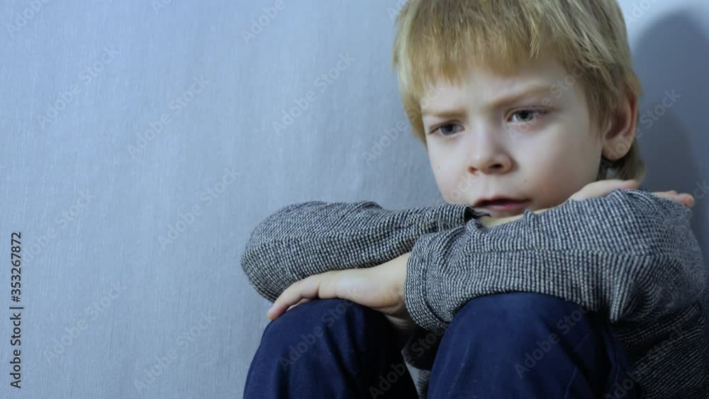 Domestic violence concept the boy is offended . sad upset boy sitting ...