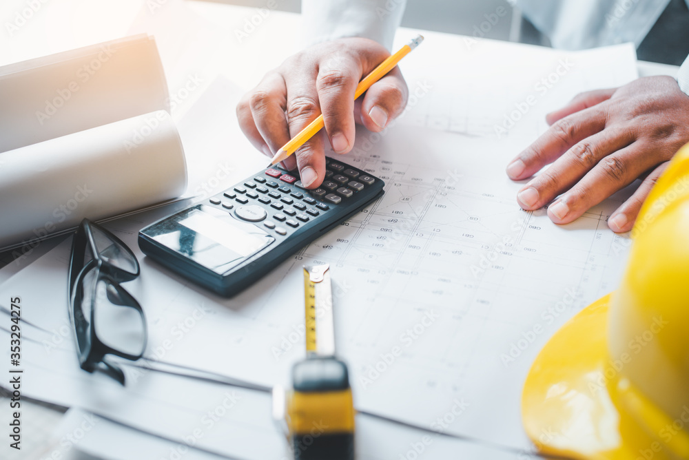 engineer working in office with blueprints, inspection in workplace for ...