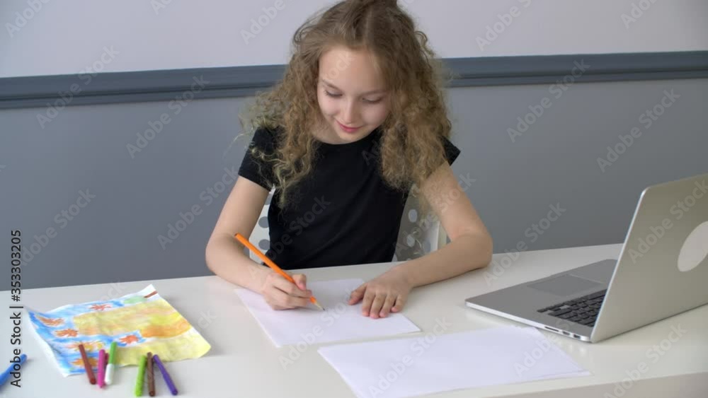 Creative girl teenager drawing picture with pencil on desk table front ...