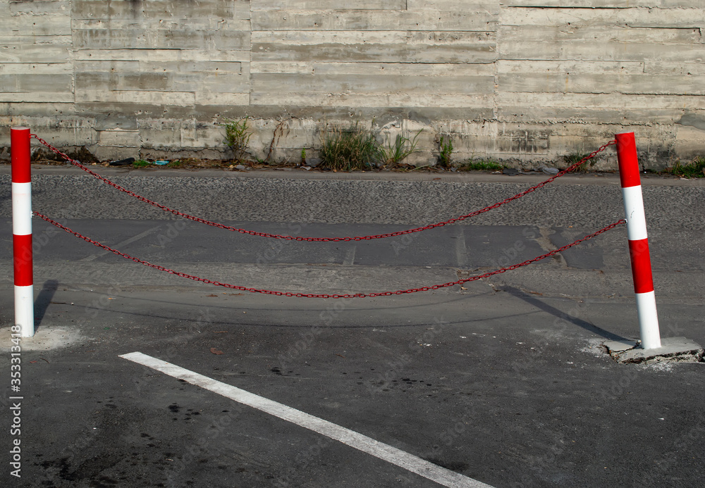 Tilted pole red and white Stand chain barrier, metal fence barricade in ...
