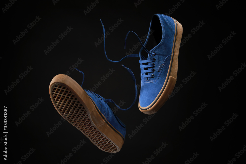 Poster Close up view of levitation blue sneakers shoes with flying ...