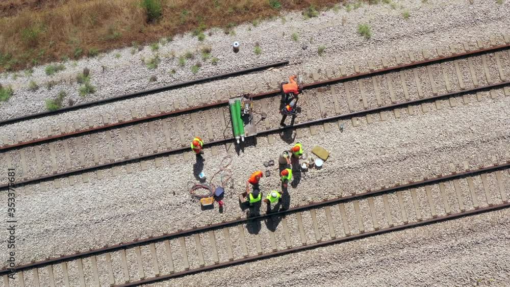 Railroad workers repairing a broken track, Top down aerial view. Stock ...