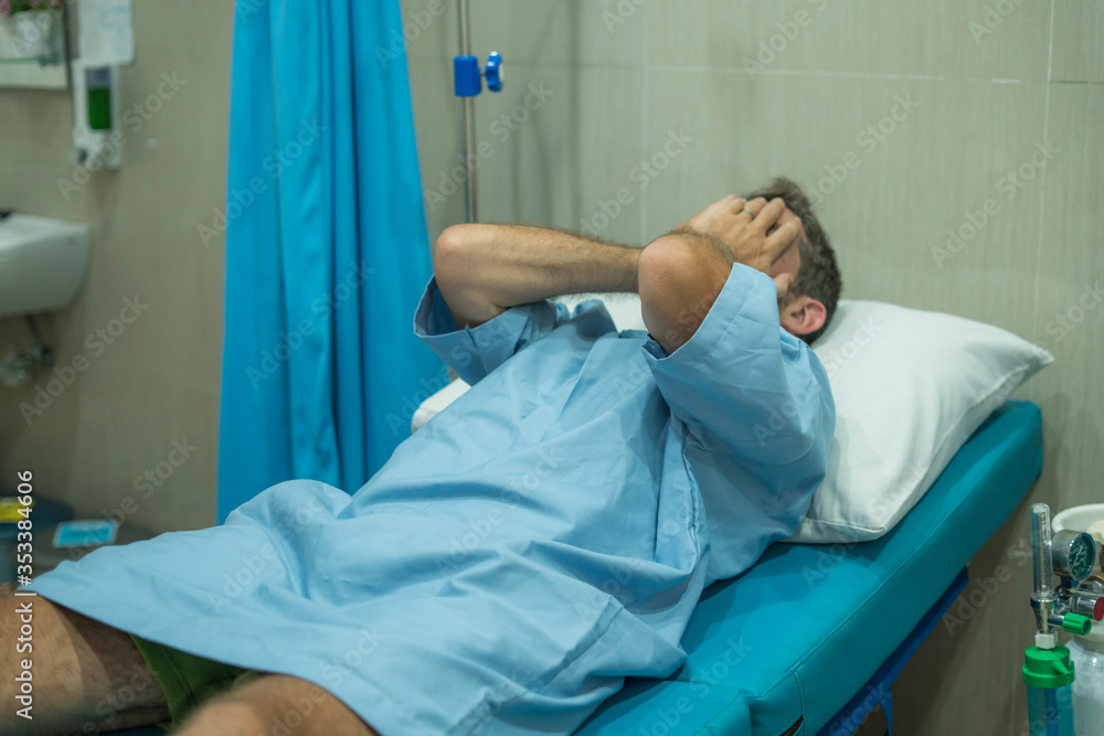 scared and worried man in pain at hospital room - attractive injured ...