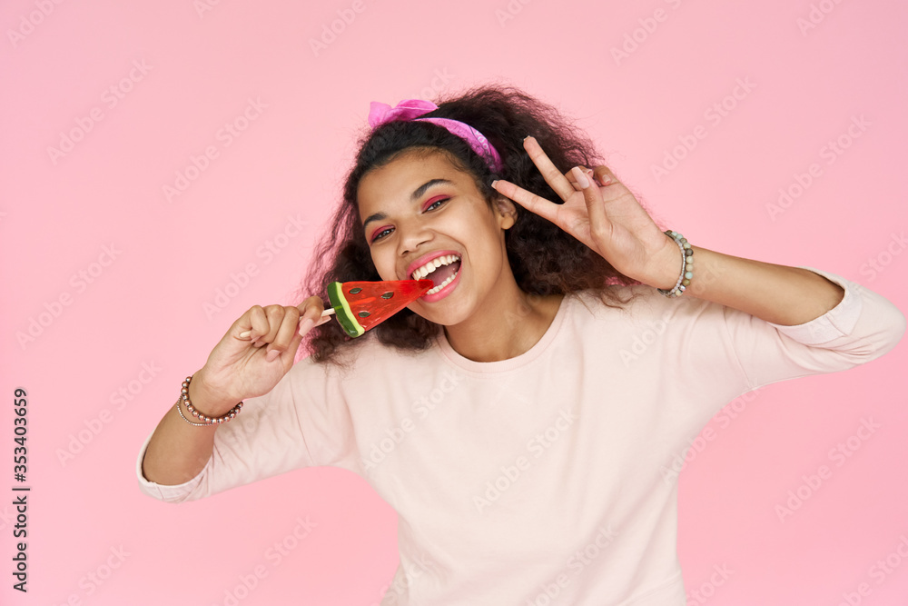 Happy cool gen z african gen z teen girl hold watermelon candy bite ice ...