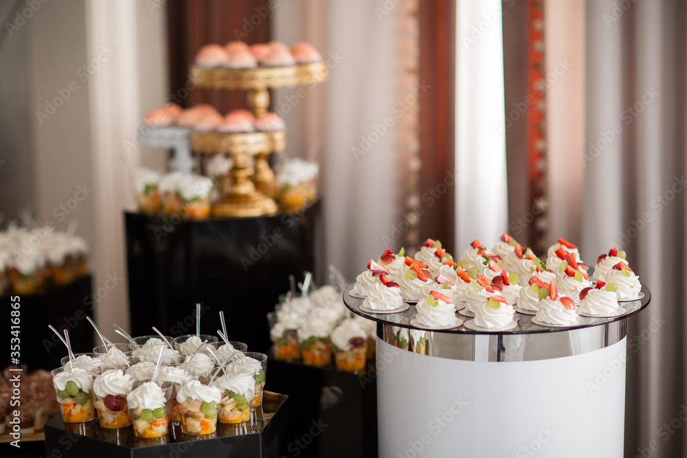 Table with sweets, buffet with cupcakes, candies. Candy bar, a table ...