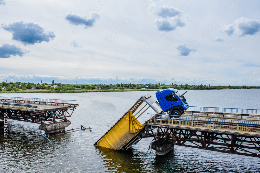 Destruction of bridge structures across the river with the collapse of ...