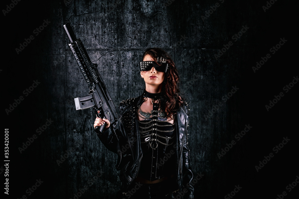 Young woman with scarified face, wearing a studded leather jacket, a ...