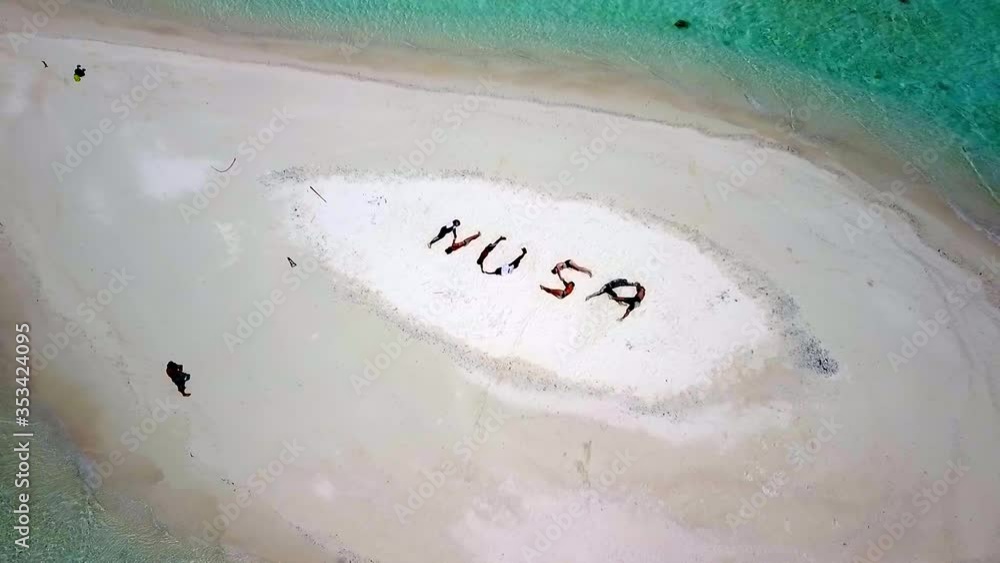 People form NUSA letters meaning island in the Indonesian language on a ...