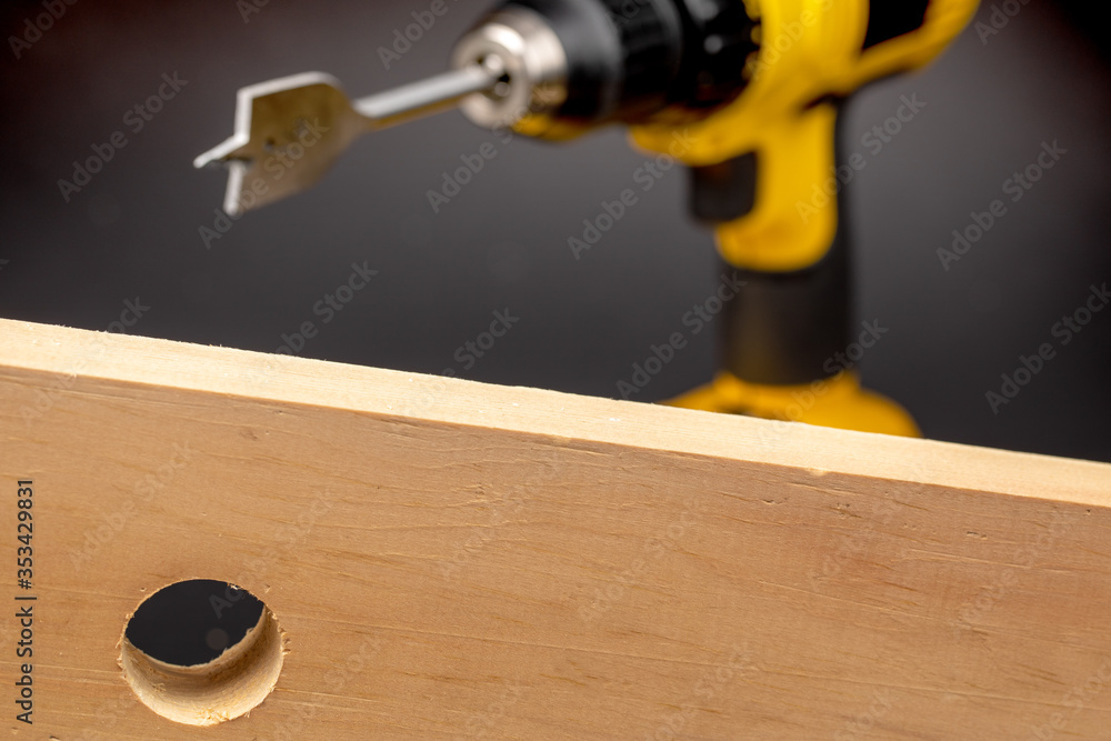 closeup of the hole made by a wood boring spade bit drilling in a piece ...