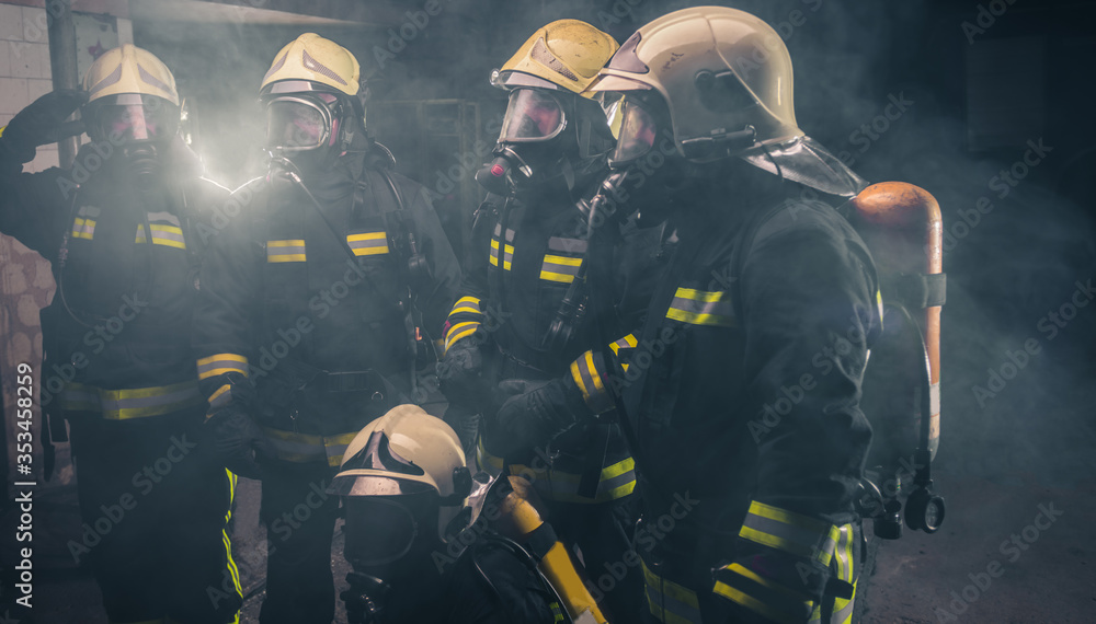 Team of fireman standing the middle of the fire extinguisher's smoke ...