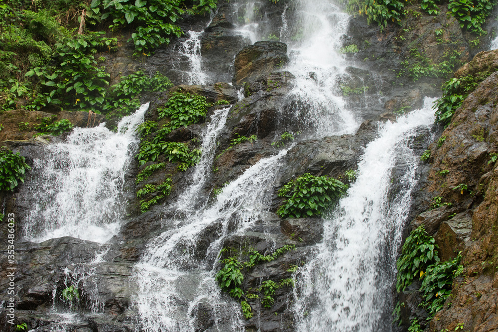 High waterfall in the rainforest on the island of Mindoro in ...