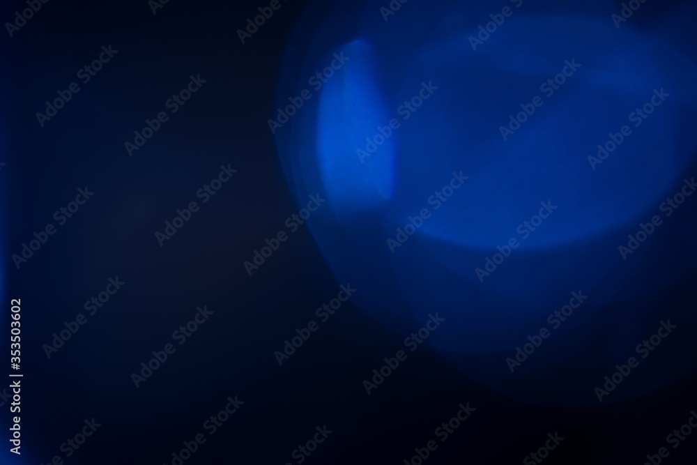 Dark background with faint blue bokeh lights for light leaks and ...