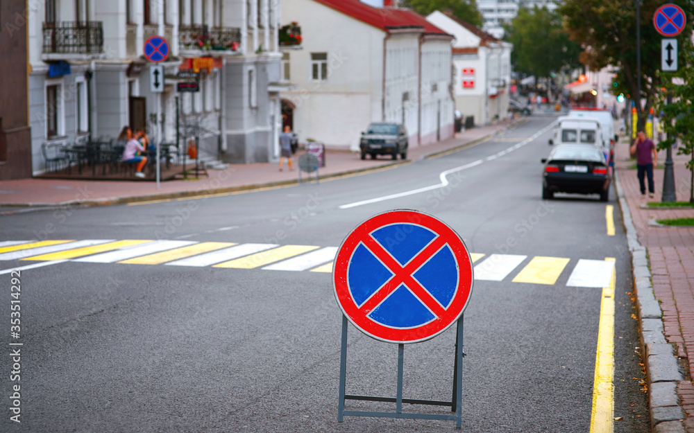 No parking, road sign is in front of pedestrian crossing. No parking ...