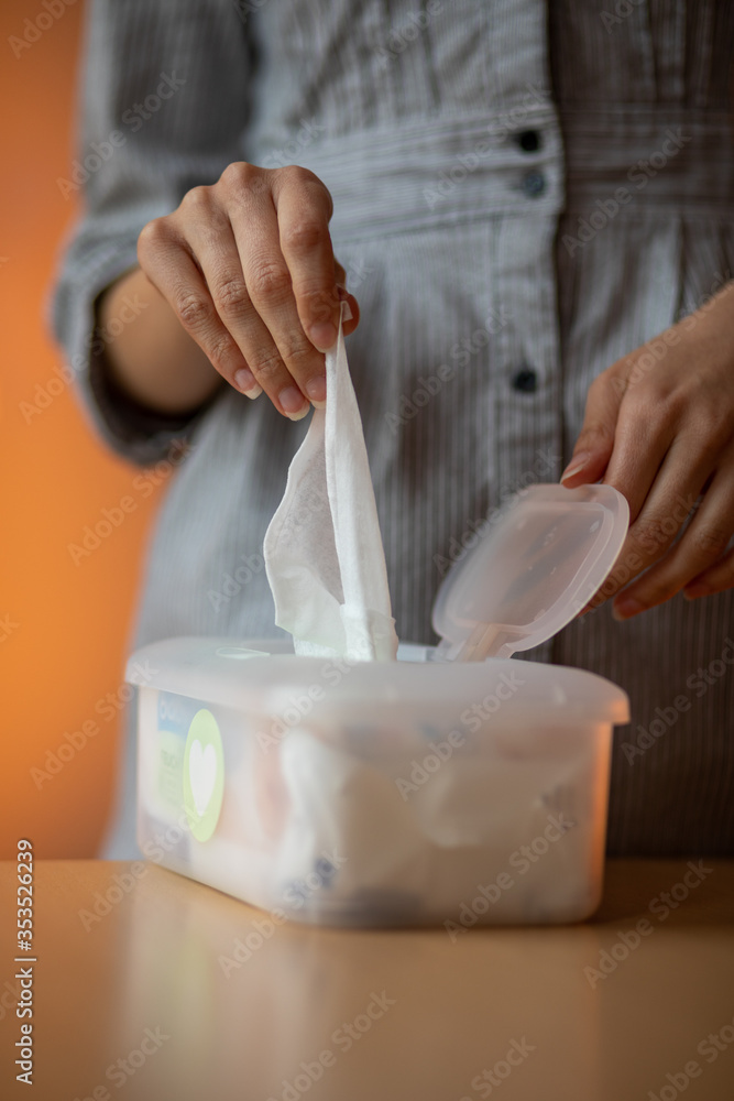 Wet wipes are universal an practical: woman take one wipe from big ...