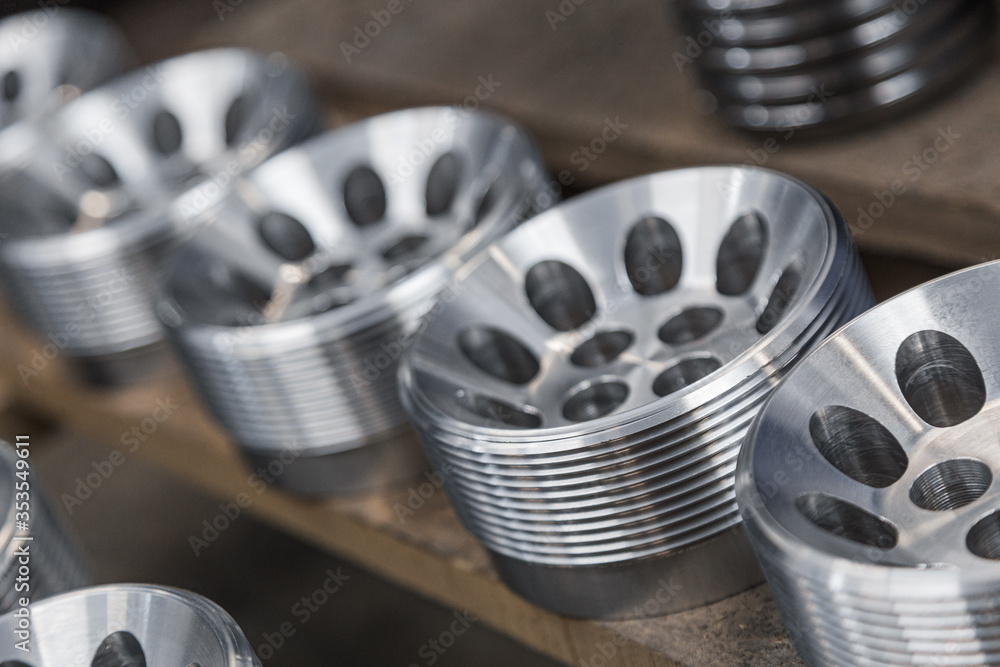Cylindrical steel metal part with round holes made on lathe. Metal ...