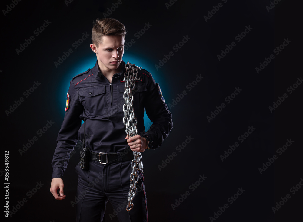 a handsome guy in a police uniform with a big chain on his shoulder ...