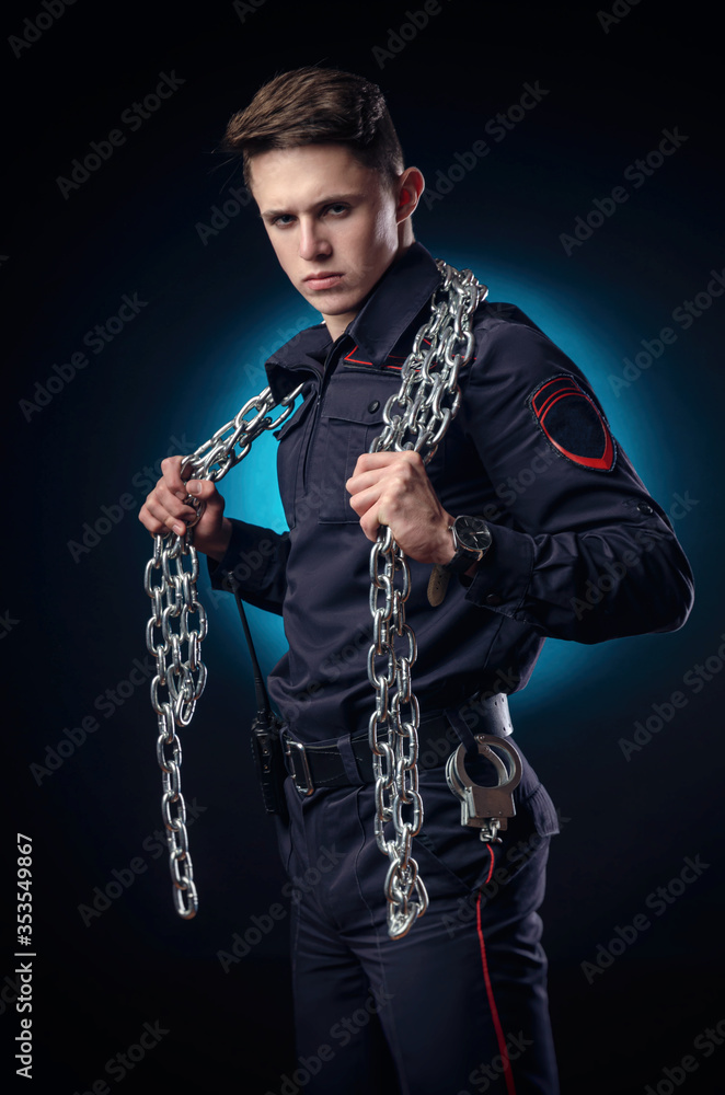 a handsome guy in a police uniform with a big chain on his shoulder ...