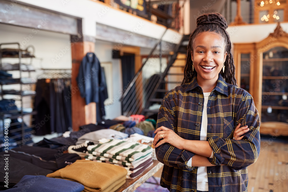 Portrait Of Smiling Female Owner Of Fashion Store Standing In Front Of ...