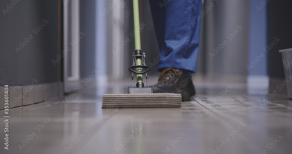 Janitor cleaning a corridor Stock Photo | Adobe Stock