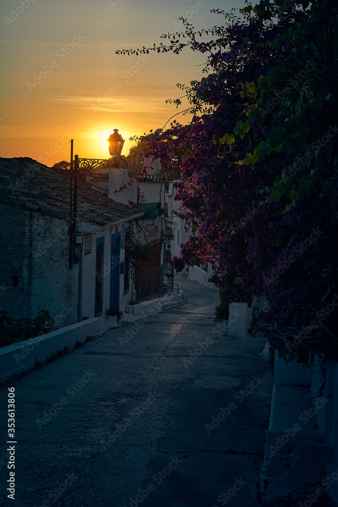 Picturesque picture of a sunset over a village with a stone path ...