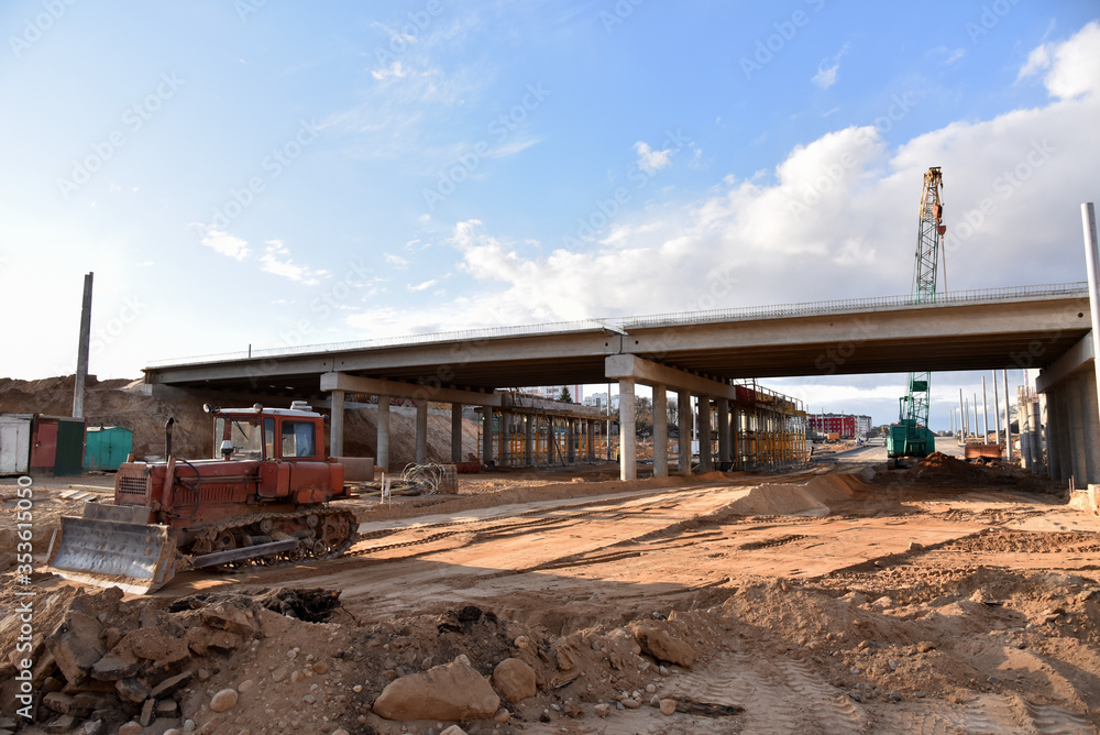 Bulldozer working at construction highway ramps and bridgeworks ...