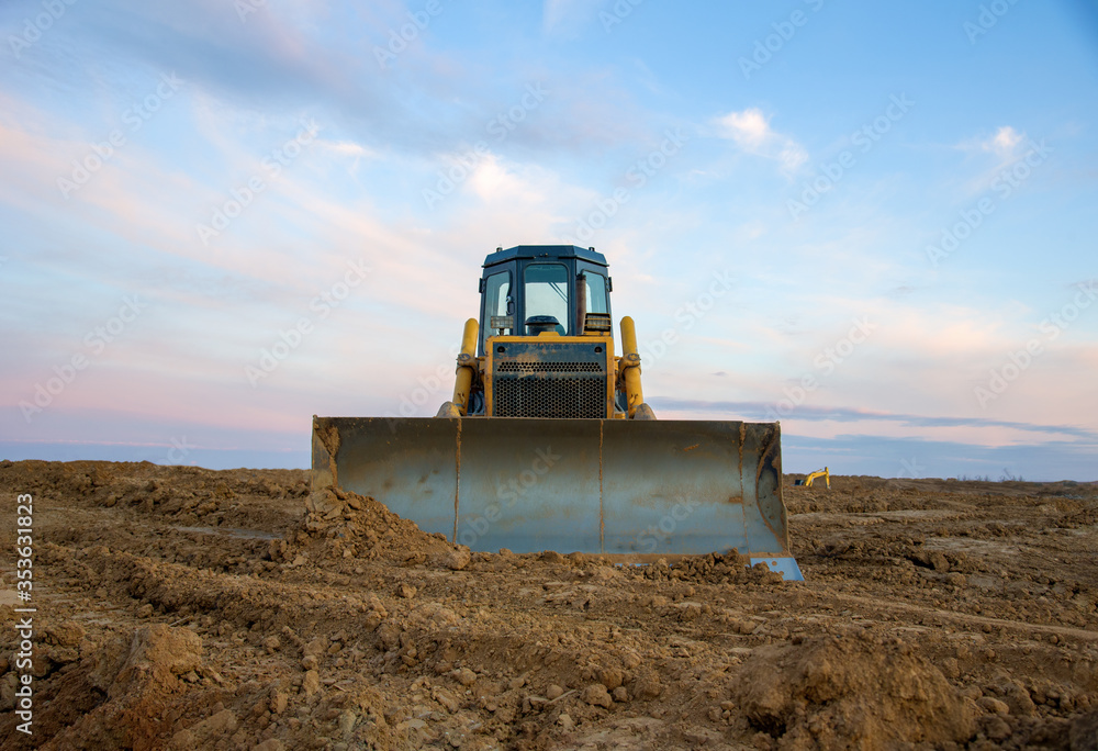 Dozer at open pit mining on sunseet background. Bulldozer for land ...
