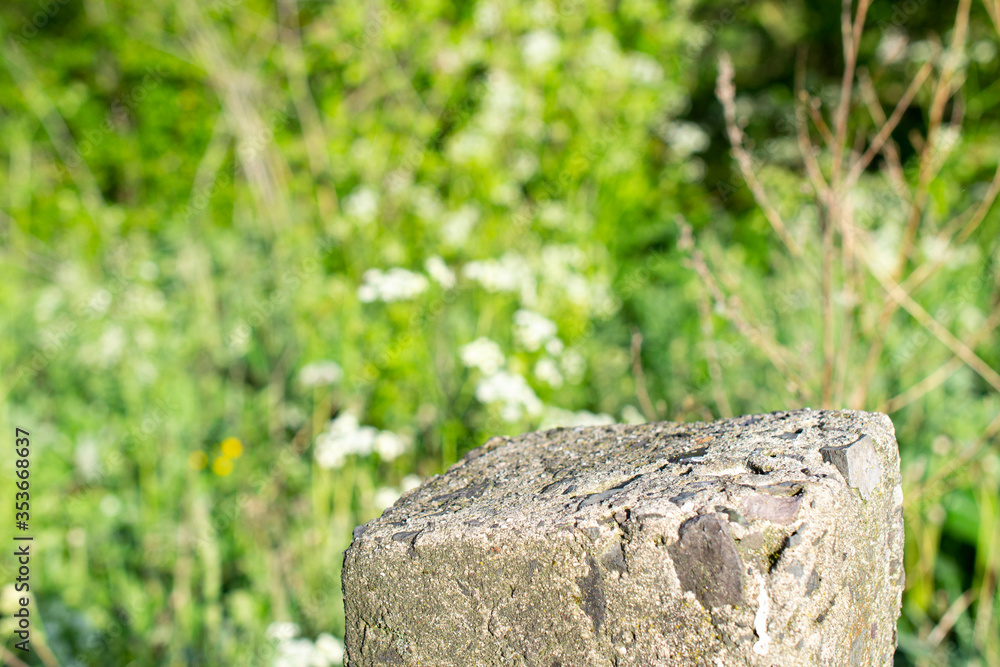Standing old gray concrete pillar with planar surface on the top as a ...