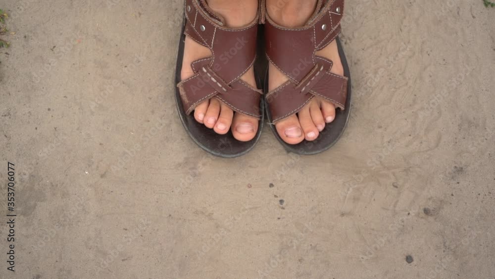 Closeup top view of two small kids legs isolated on natural ground ...