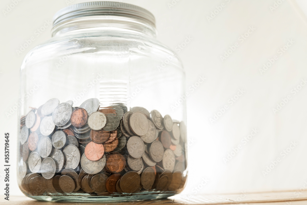 Big jar full of coins Stock Photo | Adobe Stock