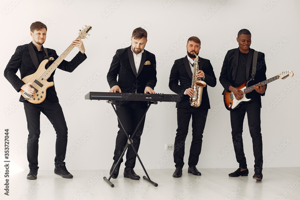 Band in a studio. Guy in a black suit. Musician with a electro keyboard ...
