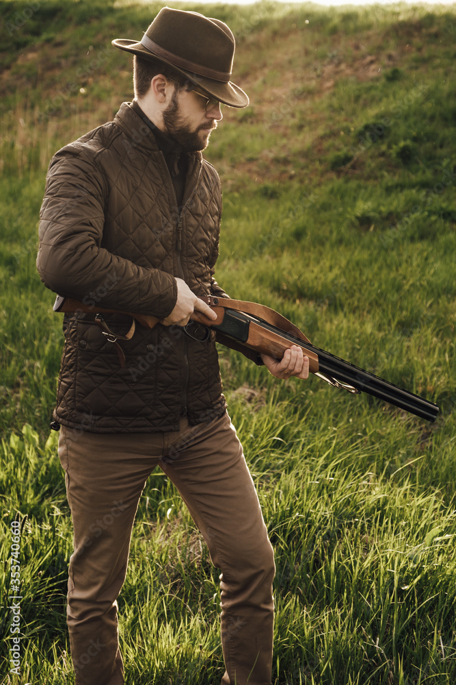 Vintage hunter walks. Rifle Hunter Silhouetted in Beautiful Sunset or ...