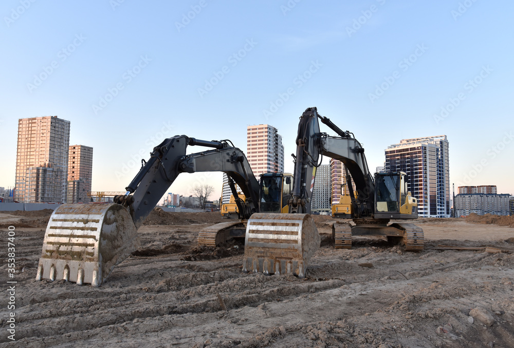Group of the excavators for digging ground, trenching and foundation at ...