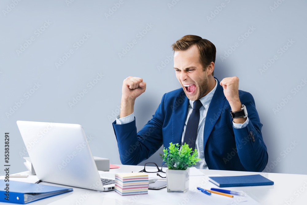 Very happy, excited businessman in blue confident suit, with clenching ...