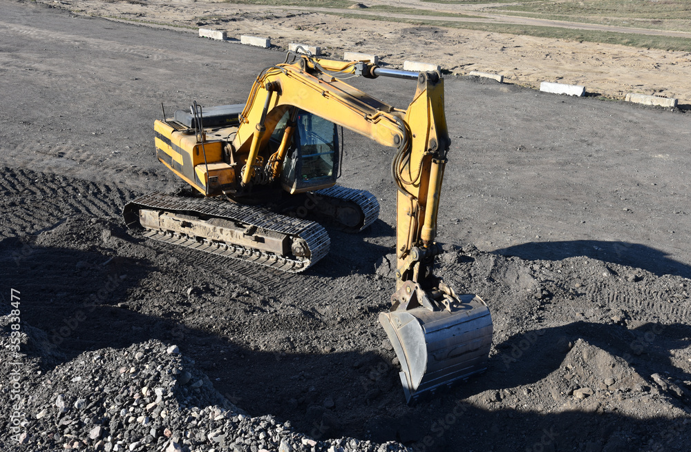 Excavator working at open pit mining. Backhoe digs gravel in sand ...
