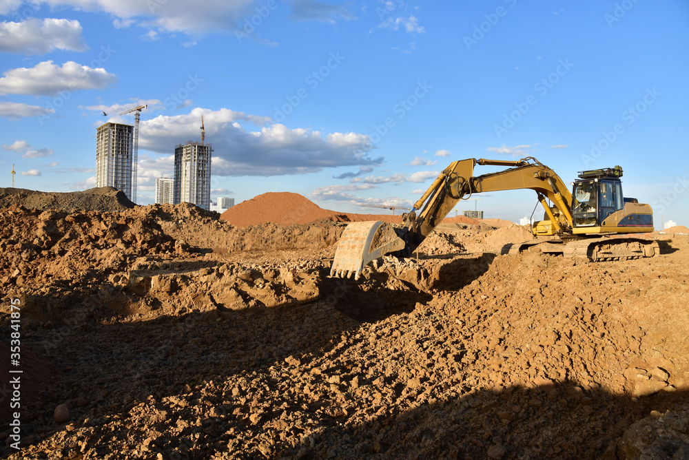 Digging the pit foundation a hole with excavator. Earthwork in ...