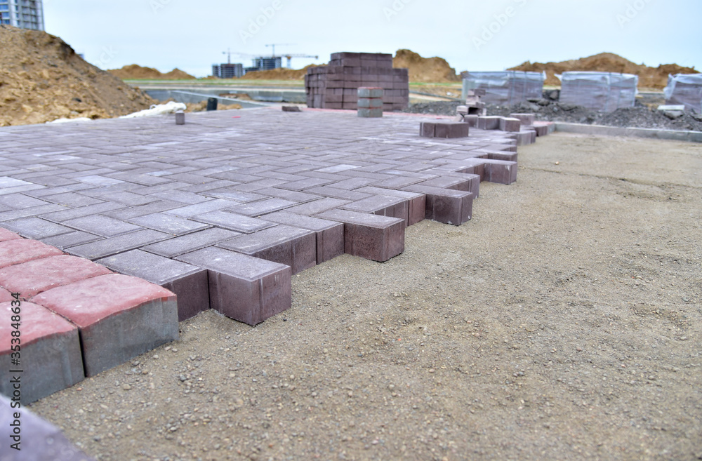 Poster Laying paving slabs and borders at construction site – Wall Art ...