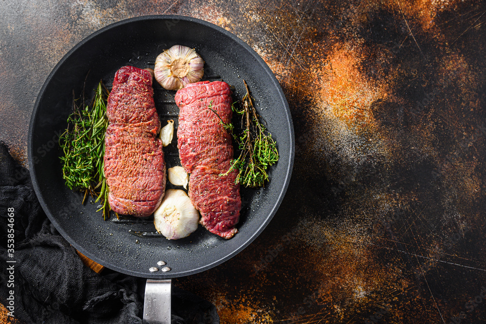 Cooking denver steak on grill frying pan with garlic and herbs just ...